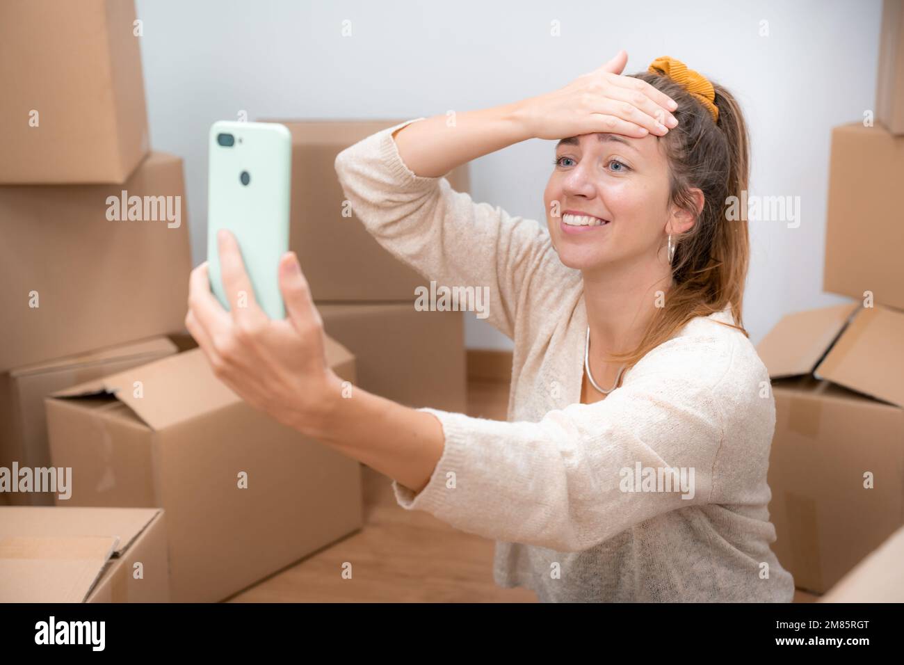 Beautiful girl with cardboard boxes unpacking in new home taking a ...