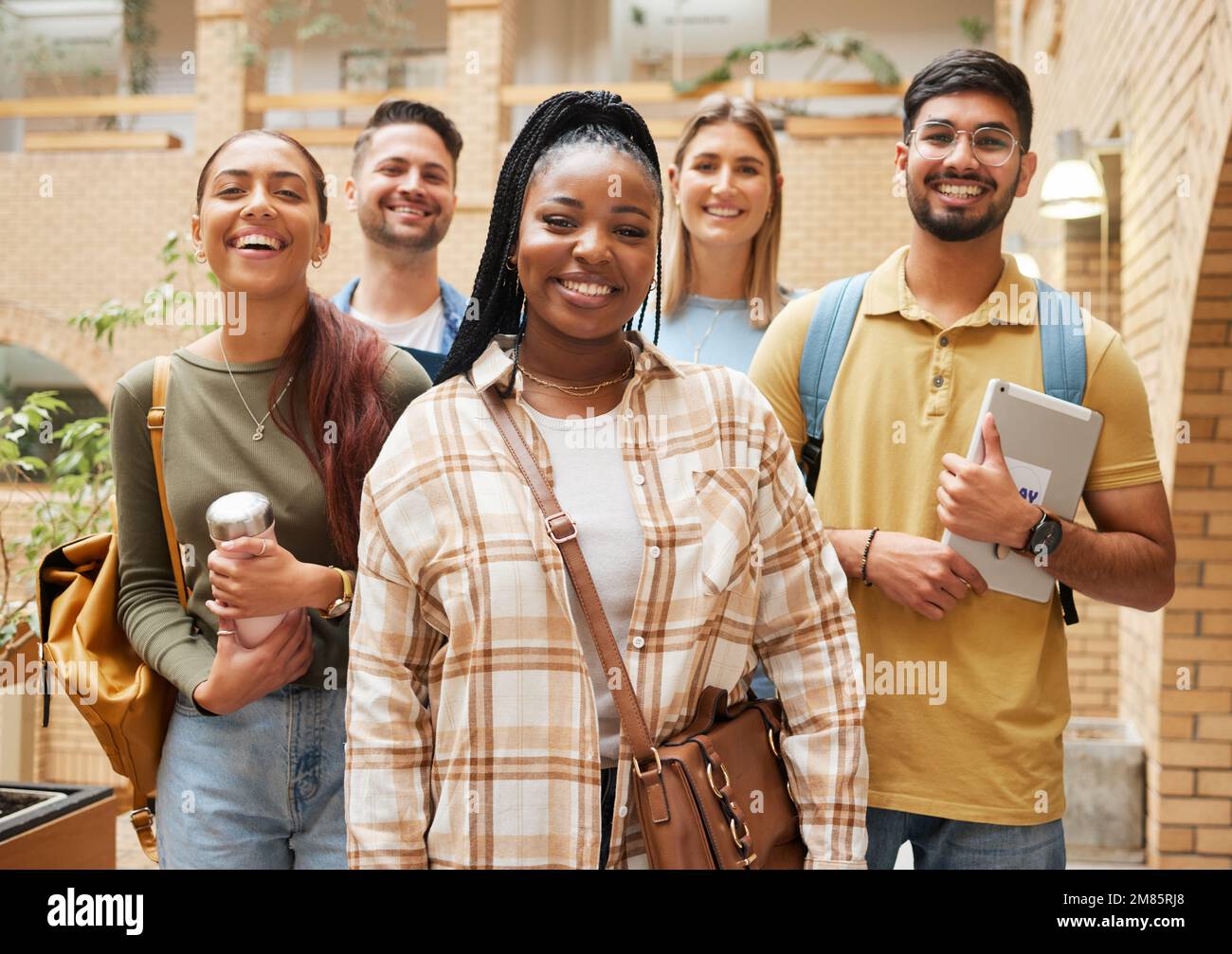 Group portrait, students and friends at university getting ready for ...