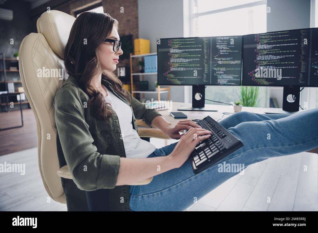Photo of smart serious lady it specialist wear glasses coding modern ...
