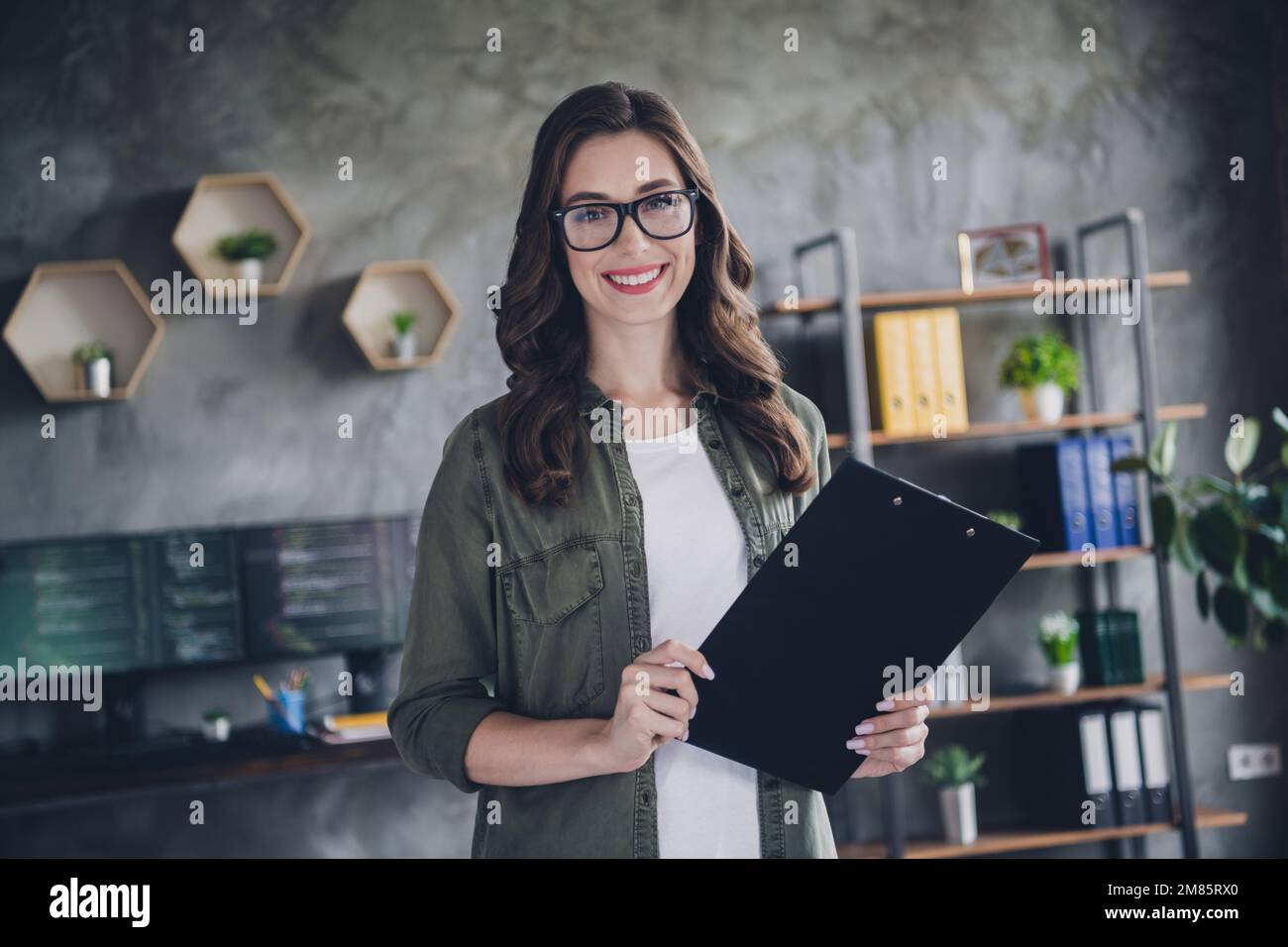 Photo of smiling positive lady hacker wear spectacles holding clipboard ...