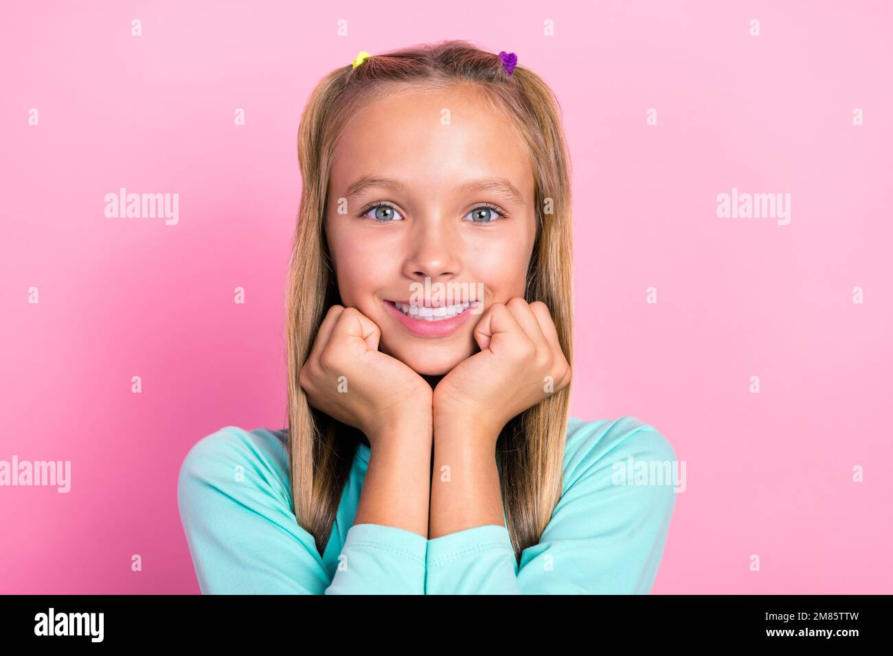 Closeup photo of young little pretty schoolgirl toothy smile touch ...