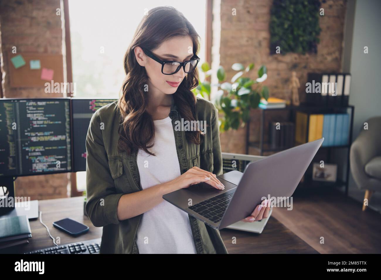 Photo of successful web designer lady use modern gadget macbook typing ...
