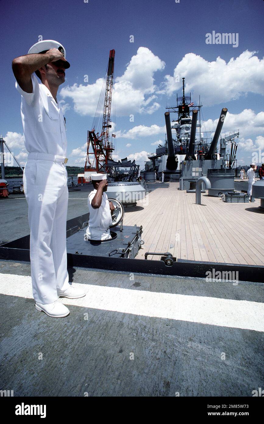 Crewmen aboard the battleship USS IOWA (BB-61) render honors to a ...