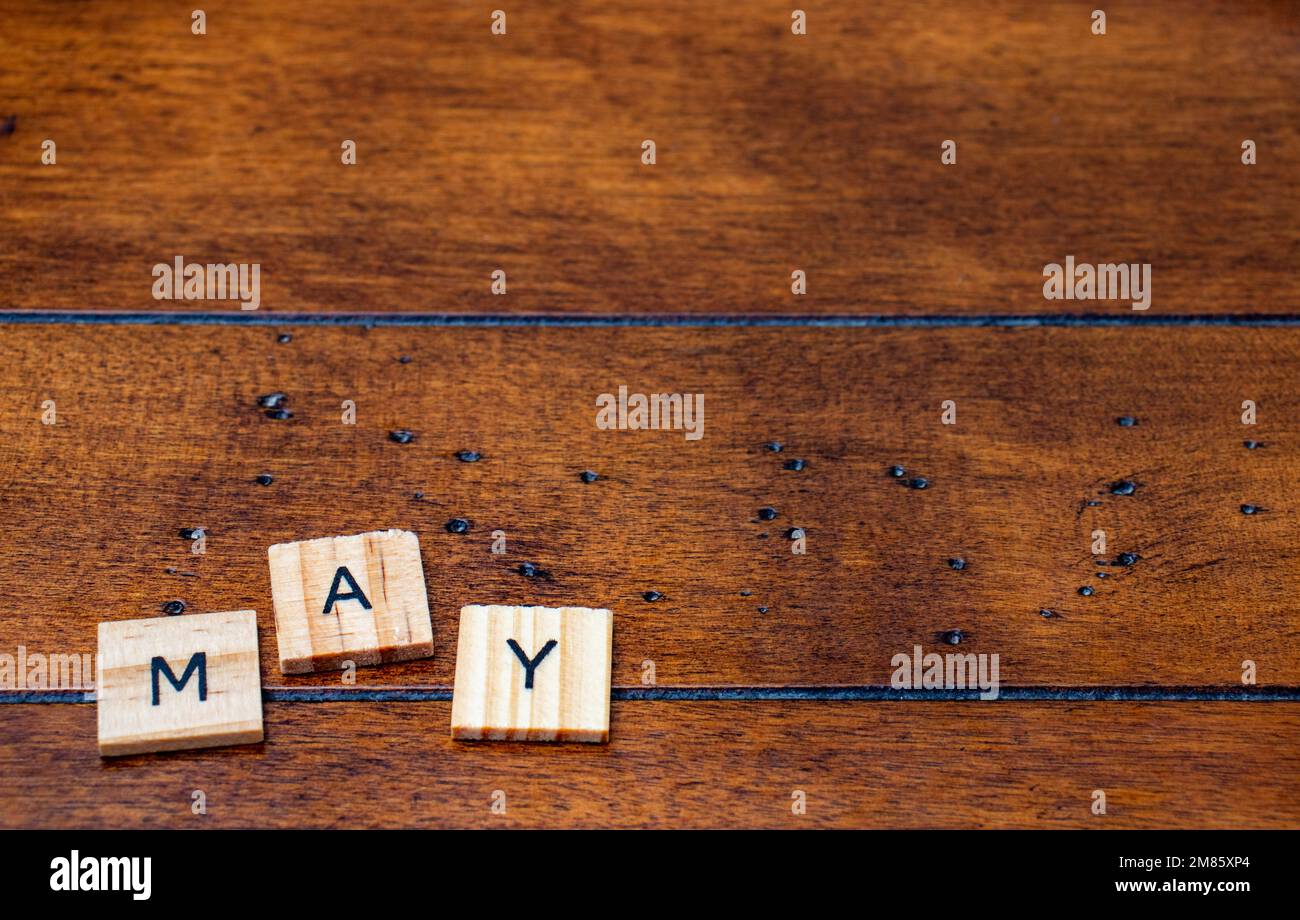 May word on letter tiles on wooden background with copy space Stock ...