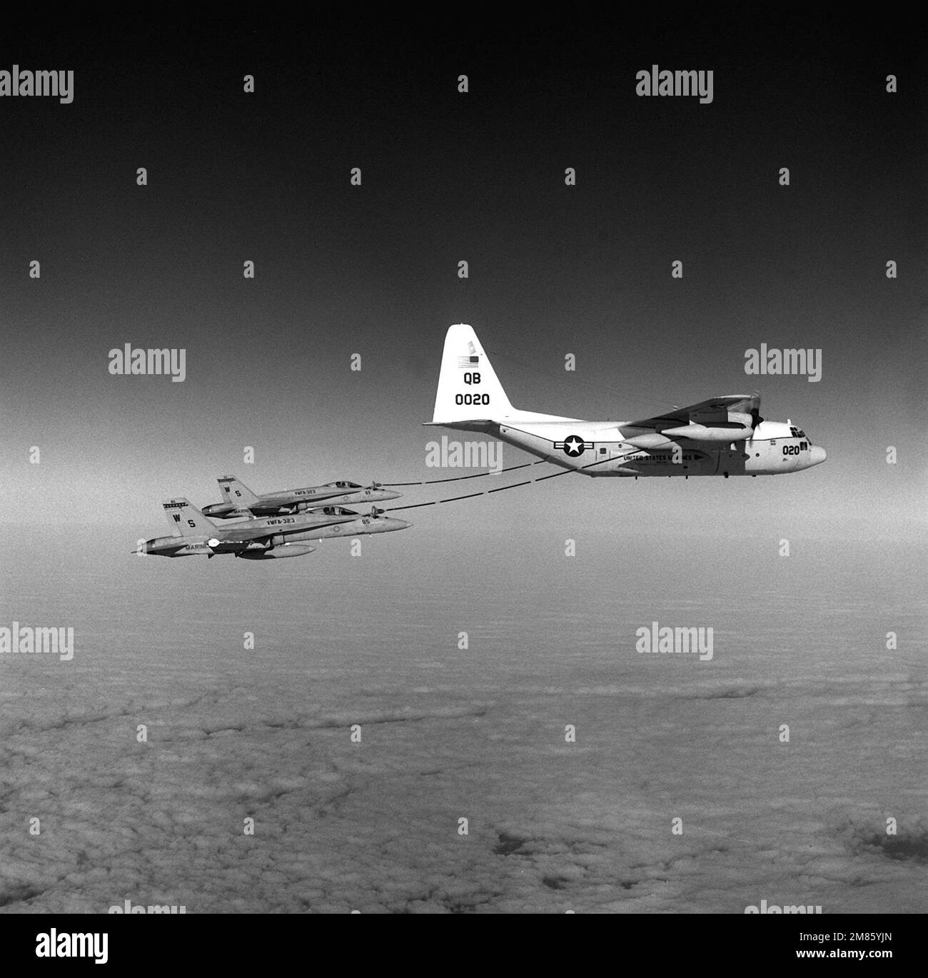 An air-to-air right side view of two Marine Fighter Attack Squadron 323 ...