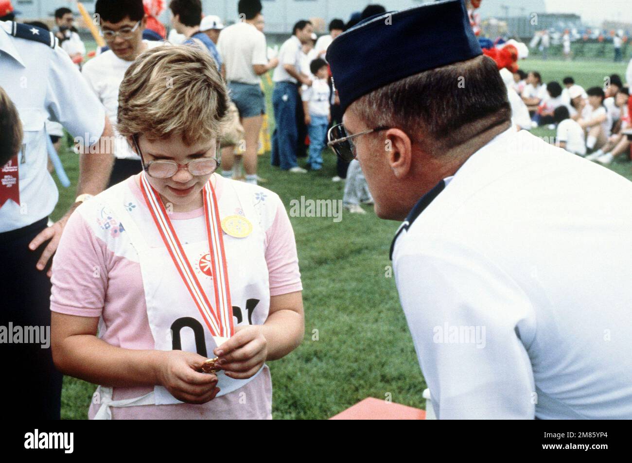 Colonel Edward P. Frey, Commander, 475th Air Base Wing, congratulates ...