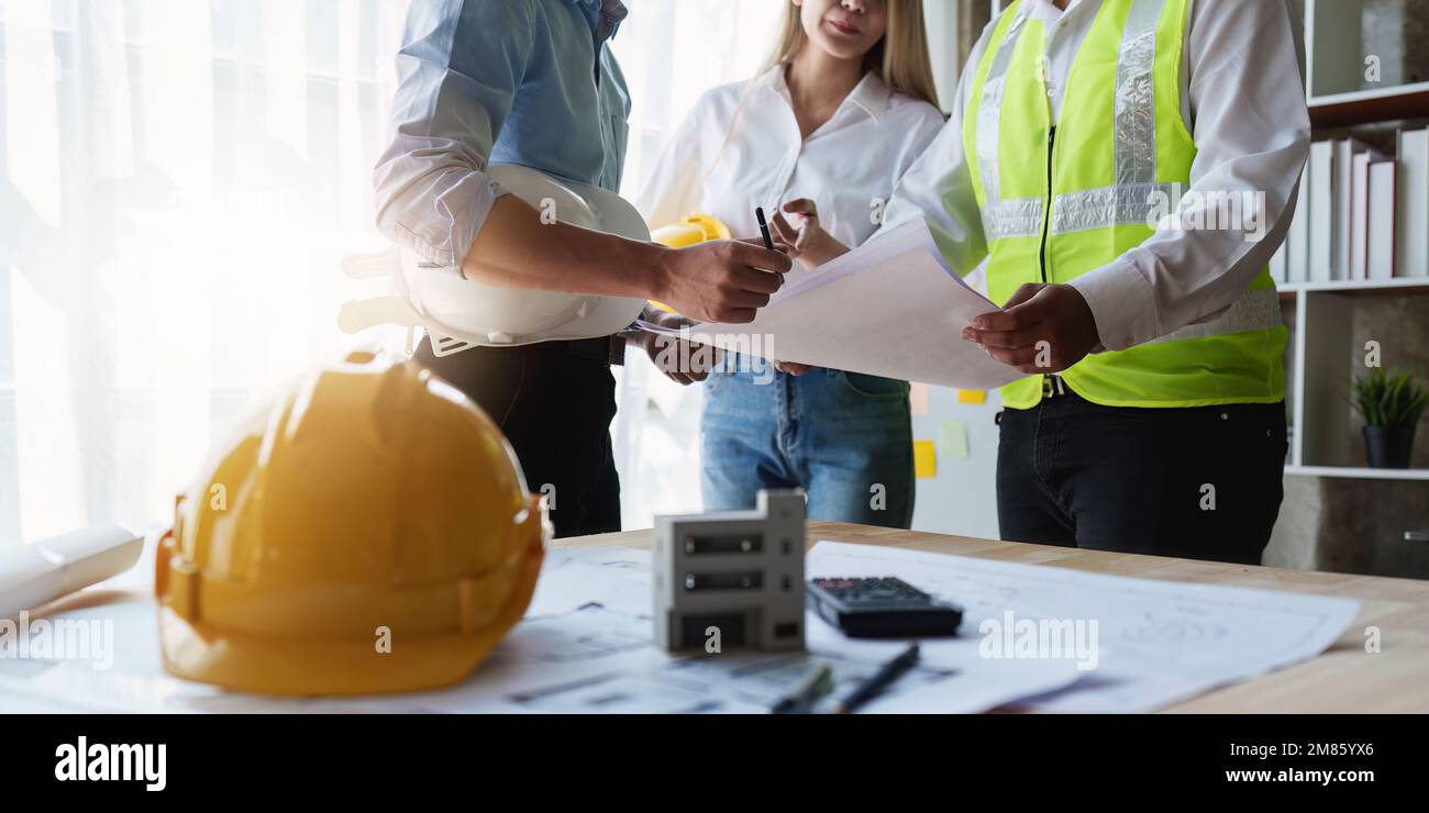 Architect team working with blueprints for architectural plan, engineer ...