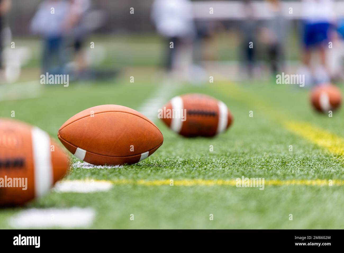 The multiple American Football balls laying on a training field Stock ...