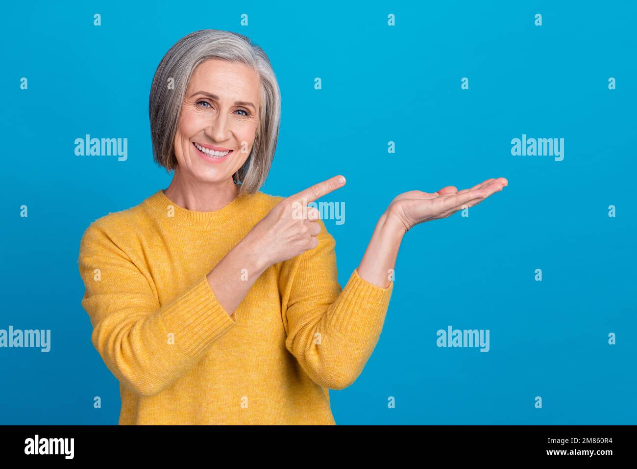 Photo portrait of senior gorgeous woman finger point palm hold empty ...