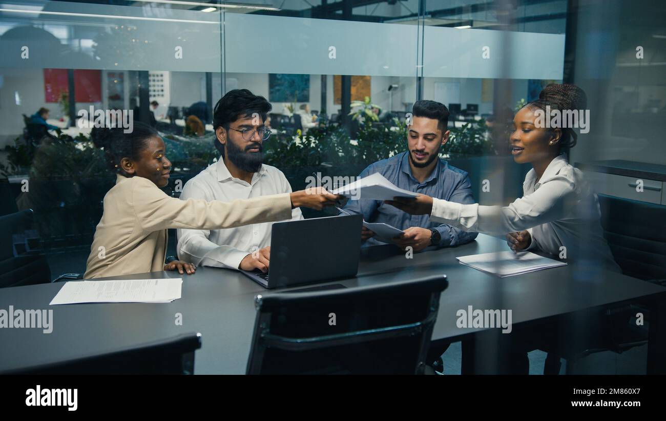 View from behind glass African American female team leader company CEO ...