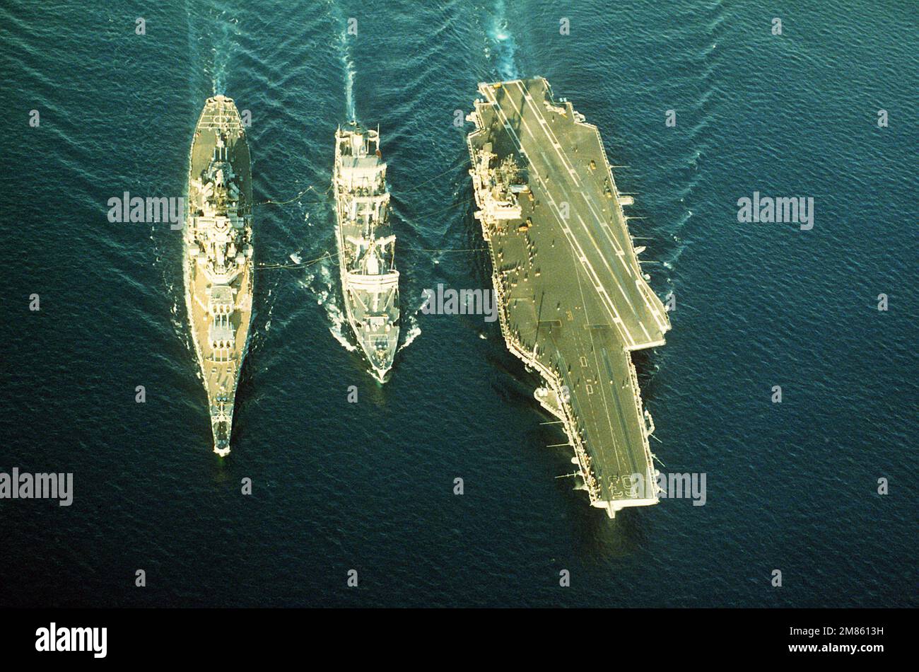 An aerial bow view of the battleship USS MISSOURI (BB-63), left, the ...