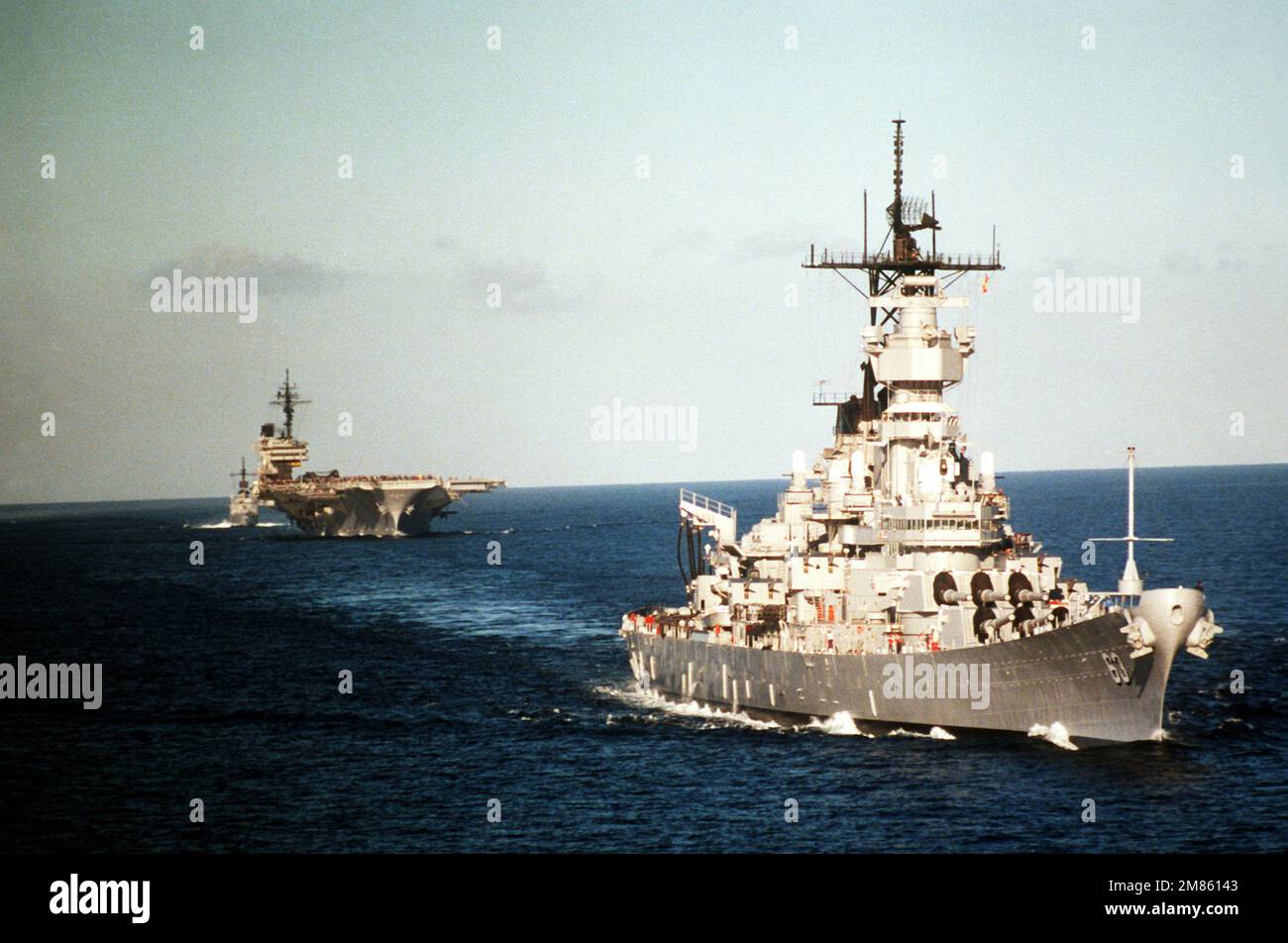 A starboard bow view of the battleship USS MISSOURI (BB-63) and the ...