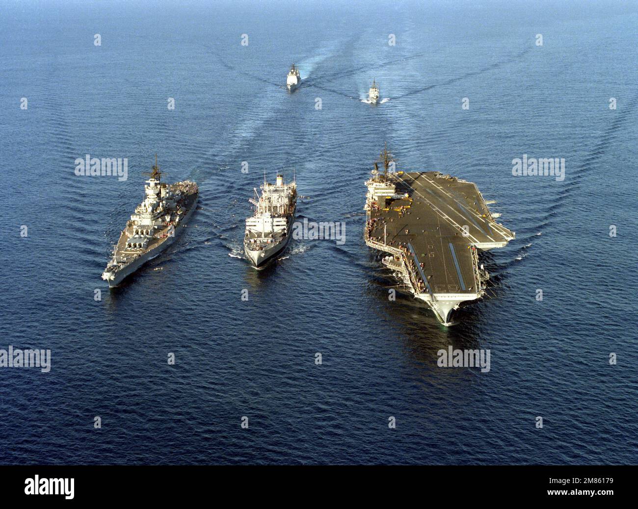 An aerial bow view of the battleship USS MISSOURI (BB-63), left, the ...