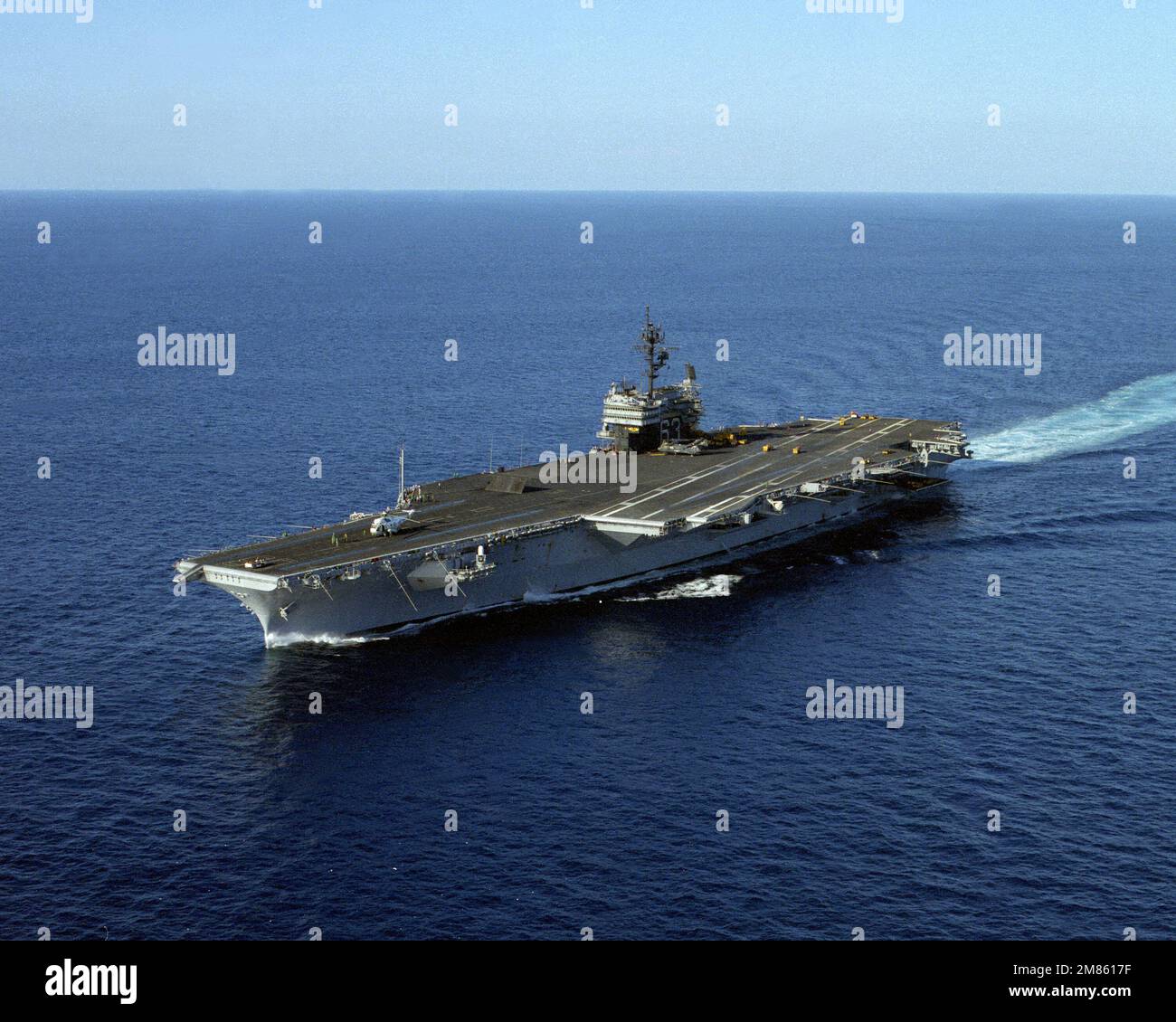 An aerial port bow view of the aircraft carrier USS KITTY HAWK (CV-63 ...