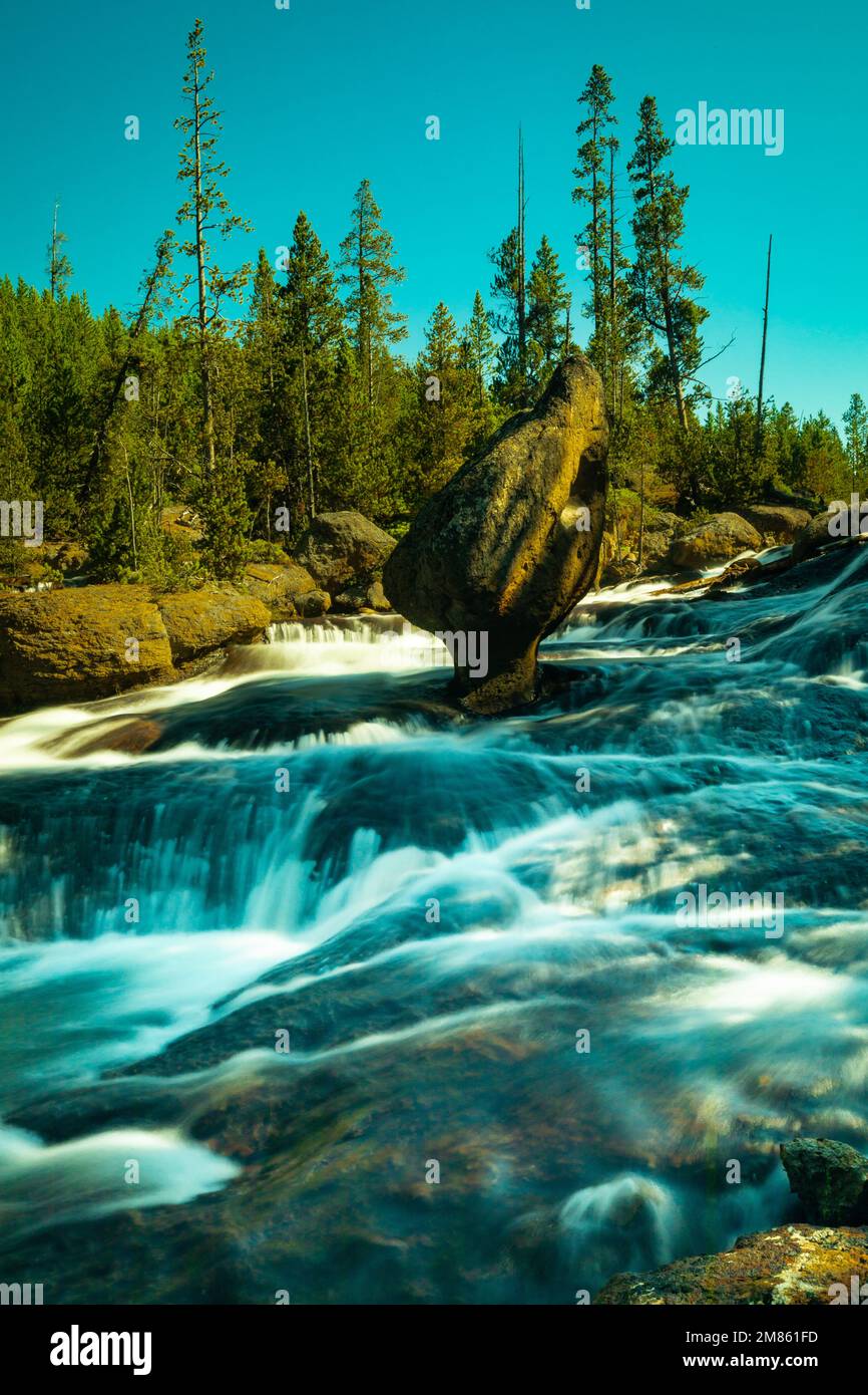 A landscape scene of tranquil Gibbon River at Yellowstone Park with ...