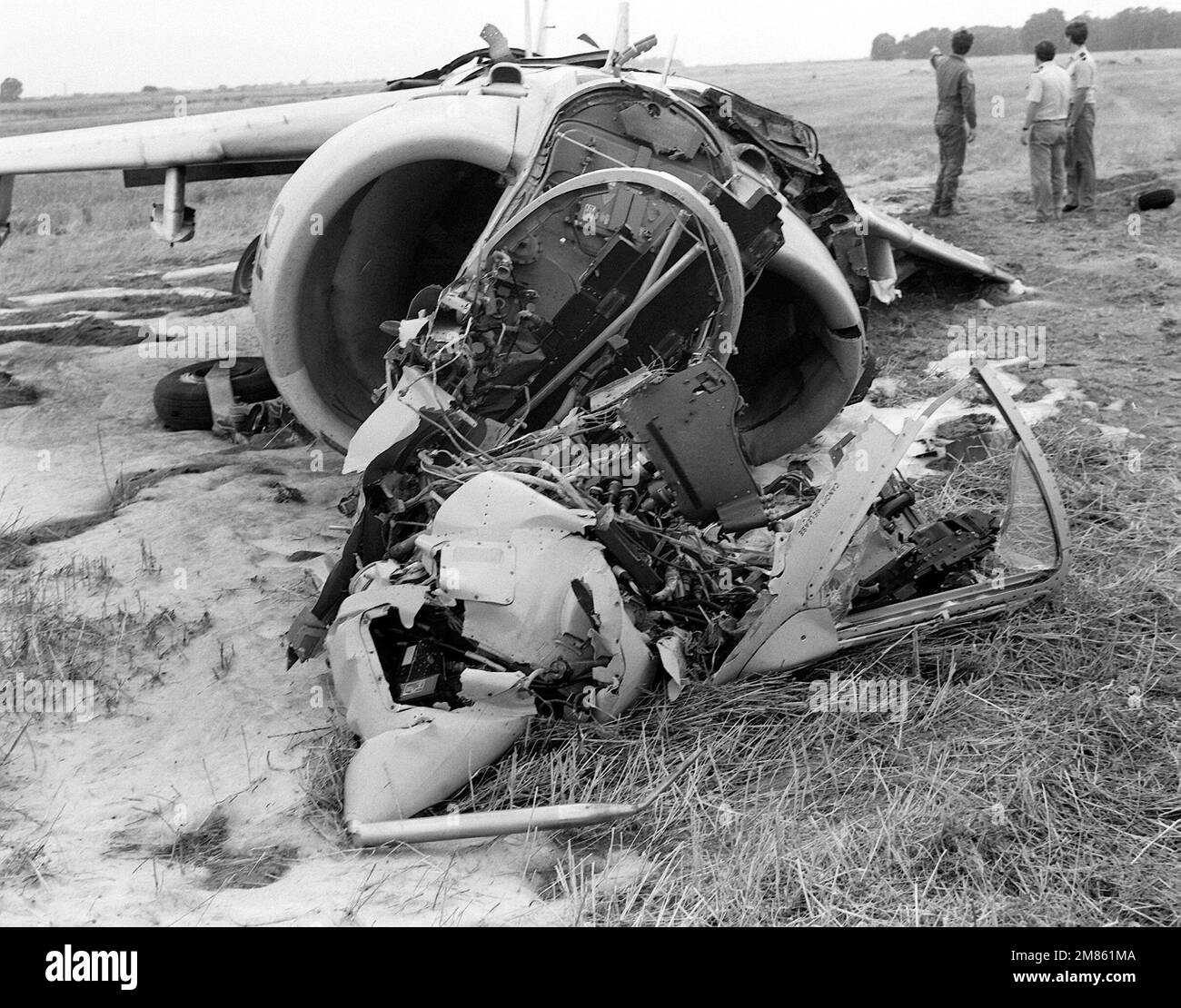 The nose and cockpit of a Spanish AV-8 Harrier lie in pieces in front ...