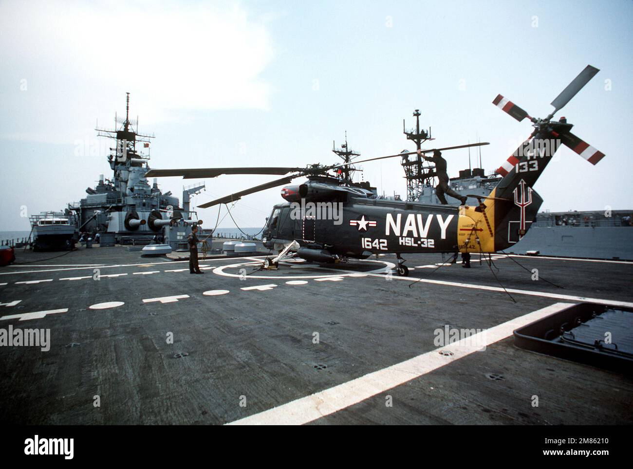 Crew members secure a Helicopter Light Anti-submarine Squadron 32 (HSL ...