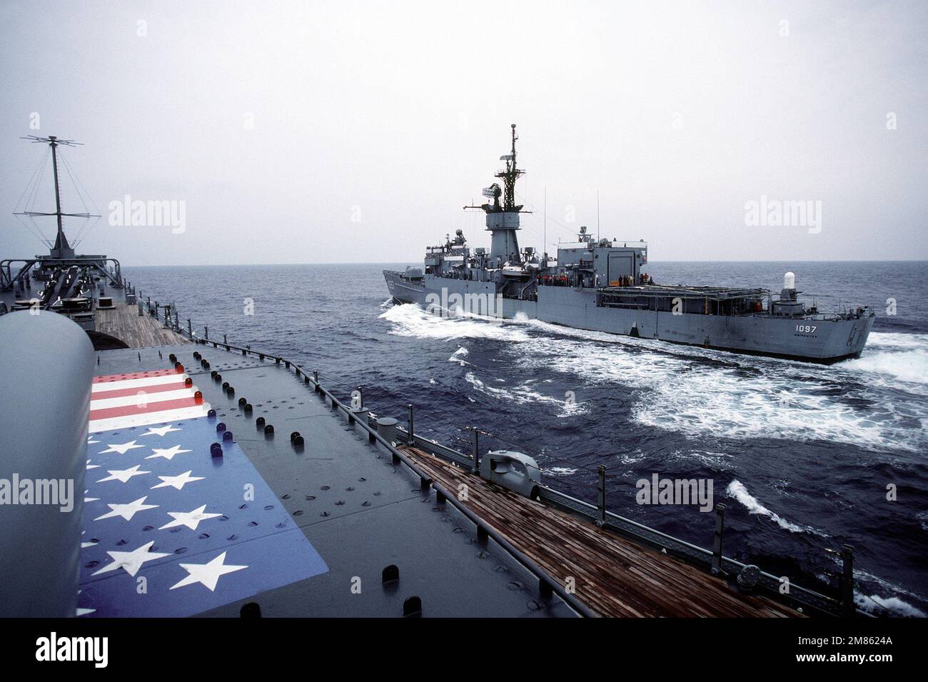 A port quarter view of the frigate USS MOINESTER (FF-1097) underway ...