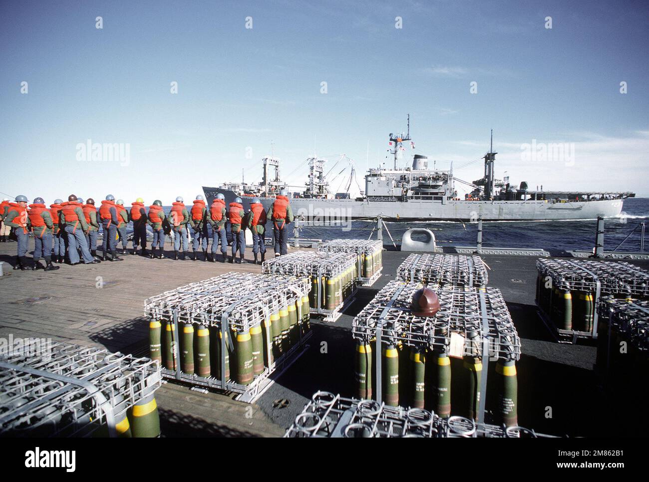 Crewman aboard the battleship USS IOWA (BB-61) stand by to transfer ...