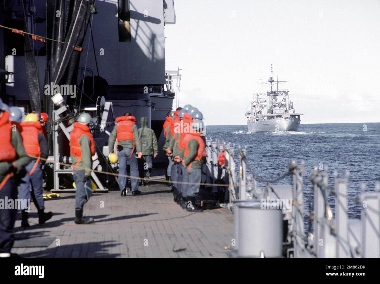 Crewmen stand by aboard the battleship USS IOWA (BB-61) as it ...