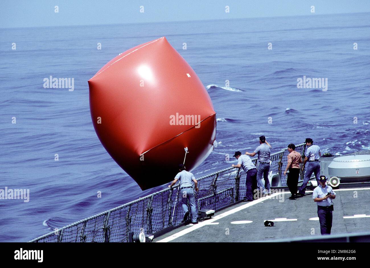 Crew members aboard the battleship USS IOWA (BB-61) deploy an ...