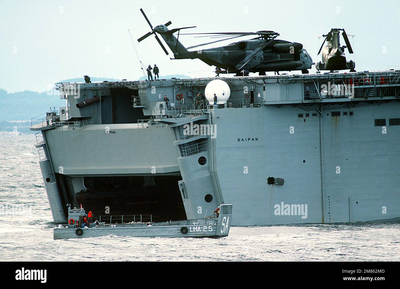 An LCM-6 mechanized landing craft is piloted past the docking well of ...
