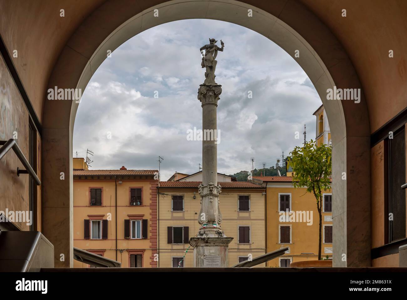 The obelisk of Piazza Mercurio square framed by an arch in the historic ...