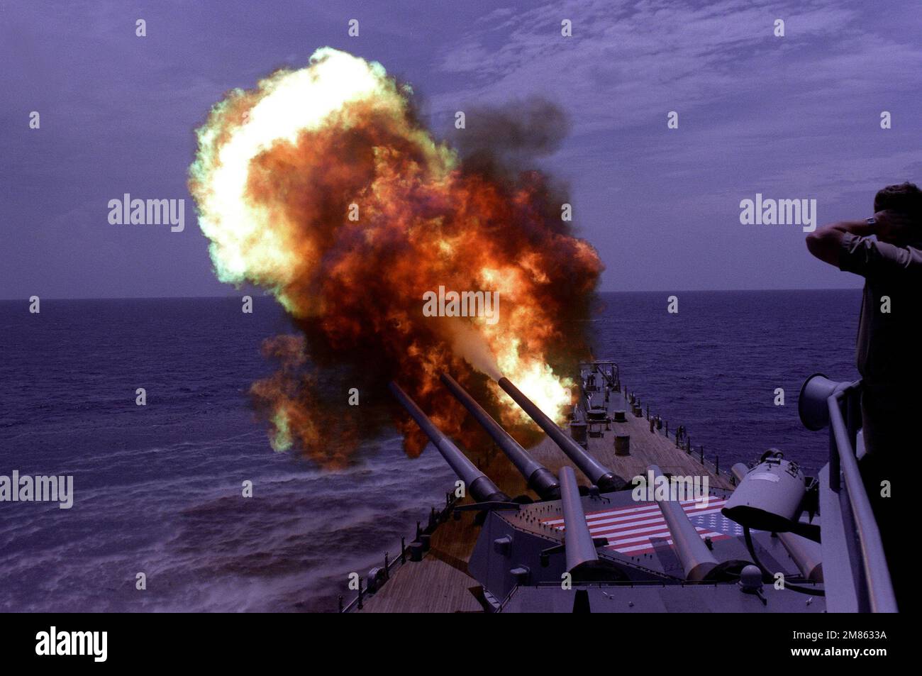 The No. 1 Mark 7 16-inch/50-caliber gun is fired to port aboard the ...