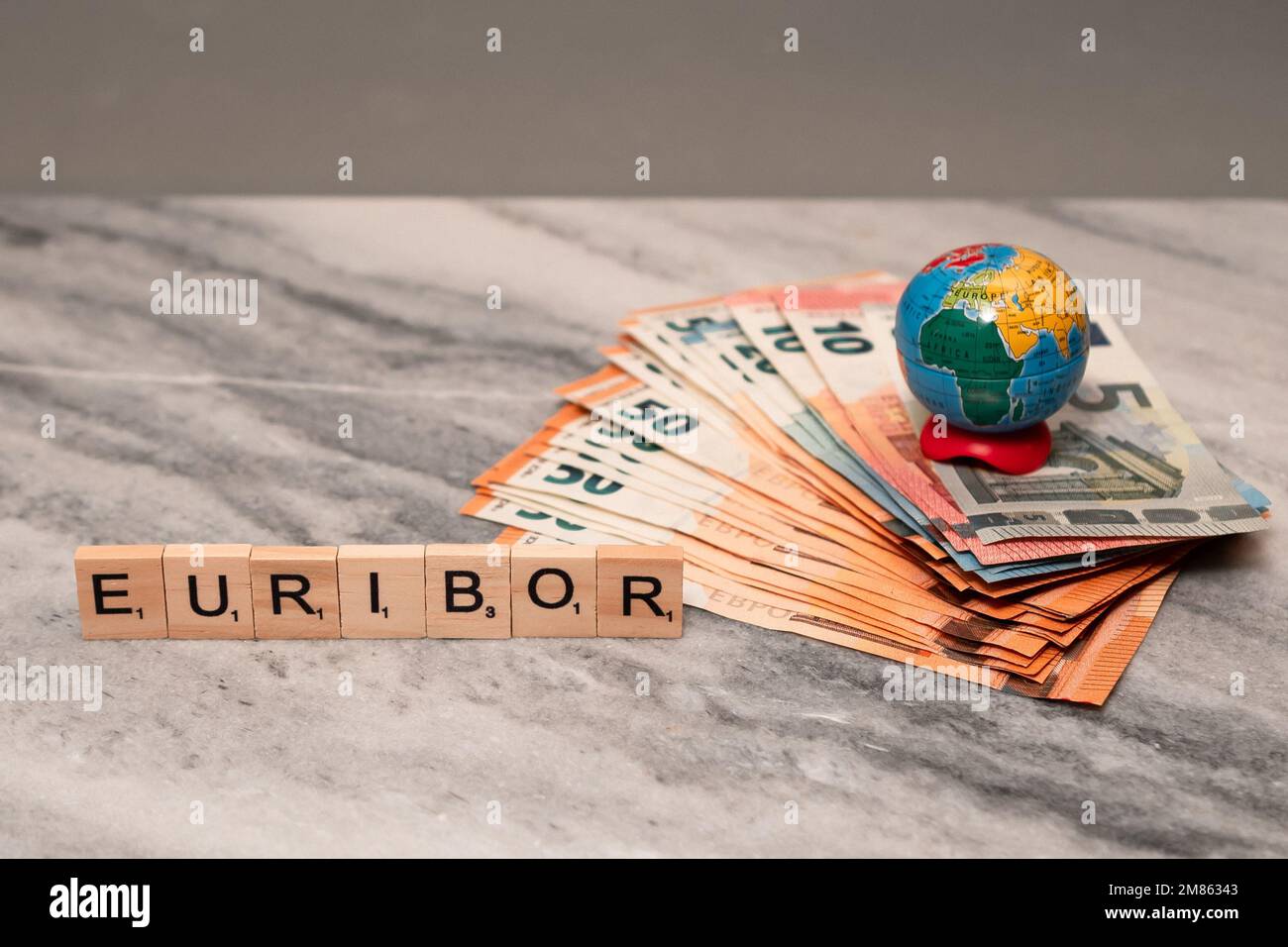 Word EURIBOR Is Written In Wooden Letters, Near Stack of Money Of 5, 10 ...