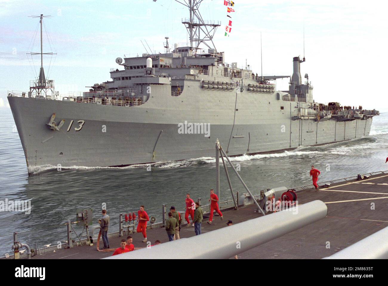 Crew members jog around the fantail of the battleship USS IOWA (BB-61 ...