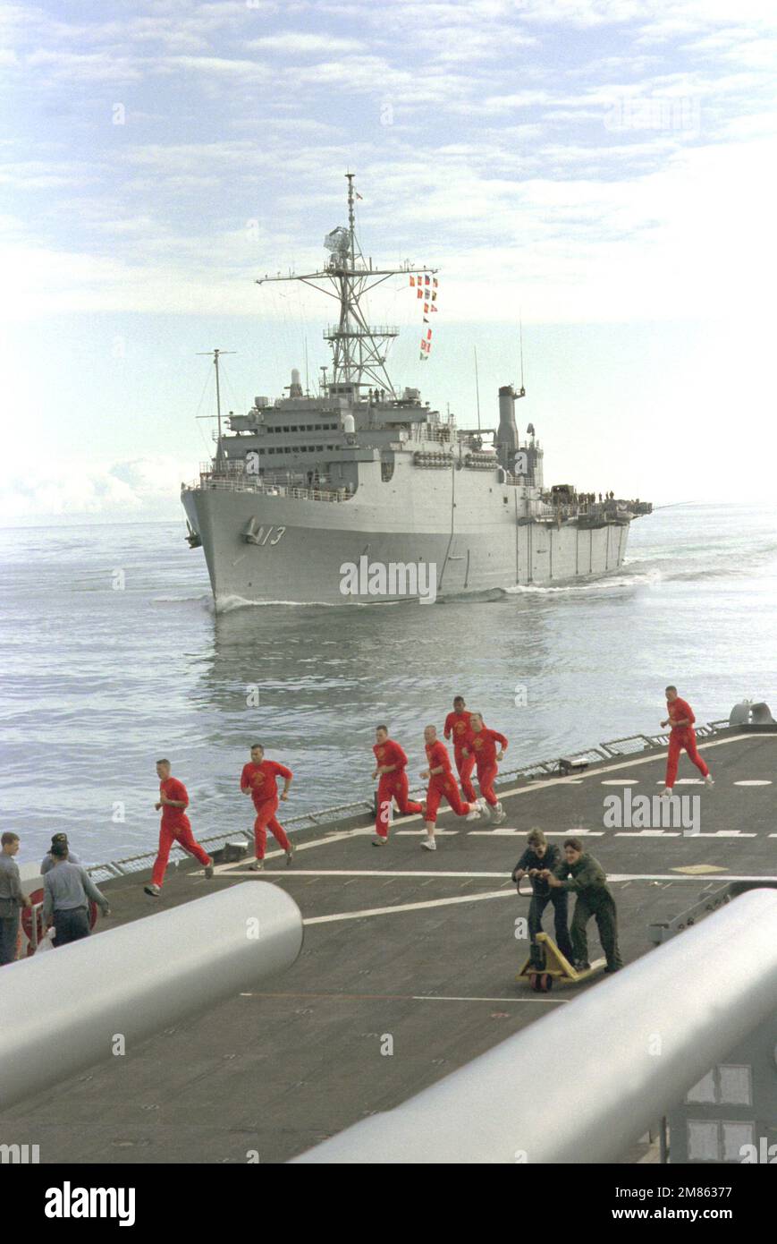 Crew members jog around the fantail of the battleship USS IOWA (BB-61 ...