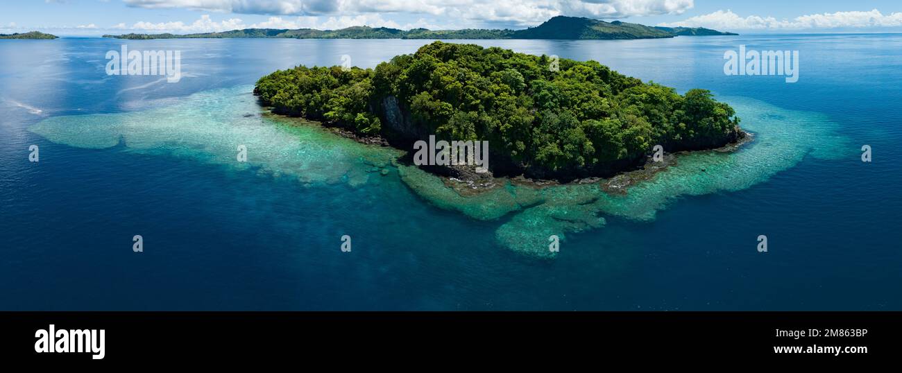A beautiful coral reef surrounds a scenic island in the Solomon Islands ...