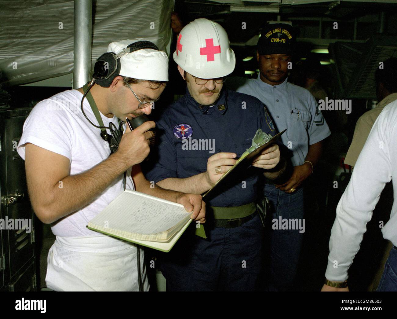 Crew members discuss sick bay operations during a mass casualty drill ...