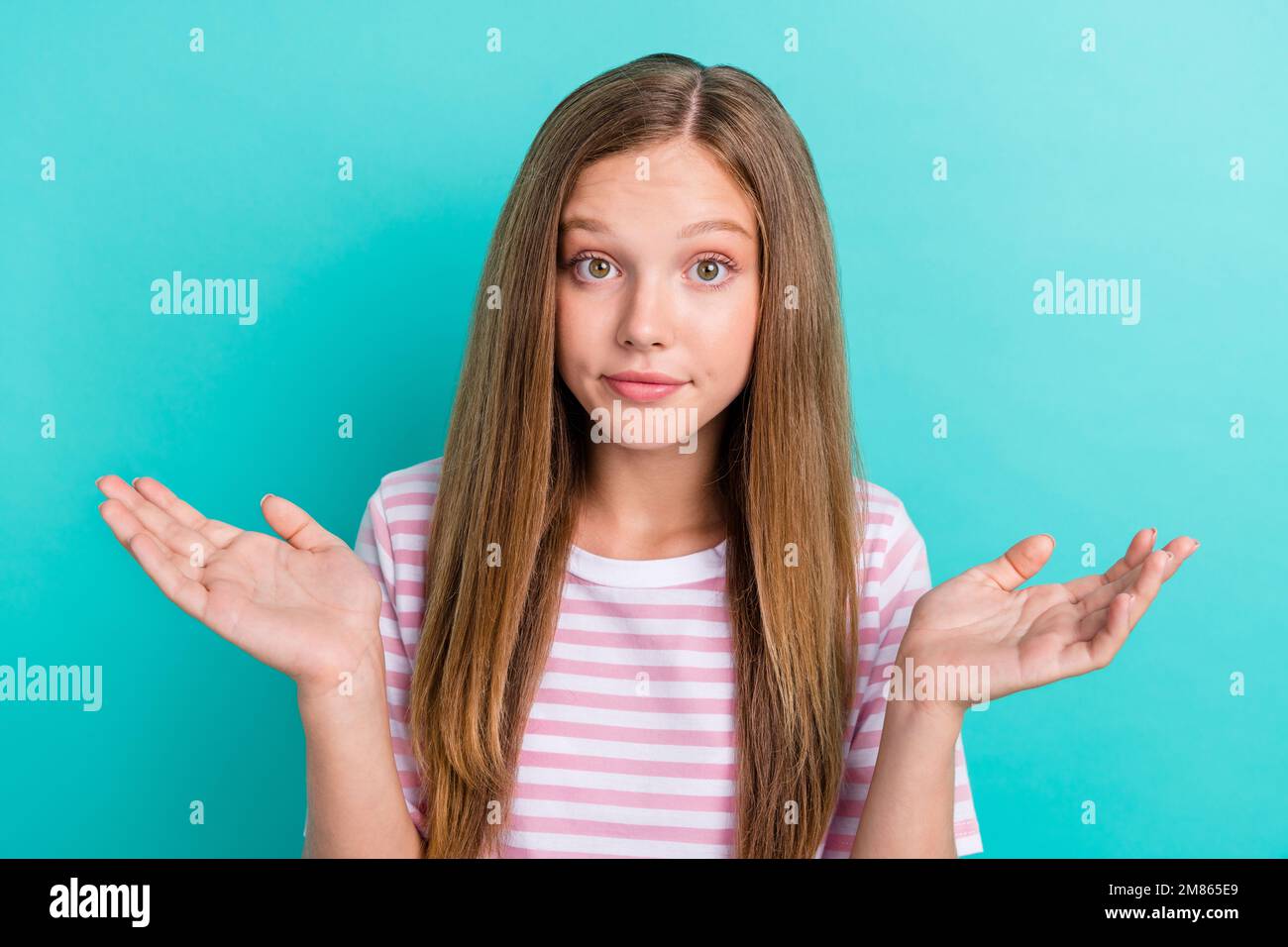 Portrait of clueless schoolgirl raise arms palms shrug shoulders do not ...
