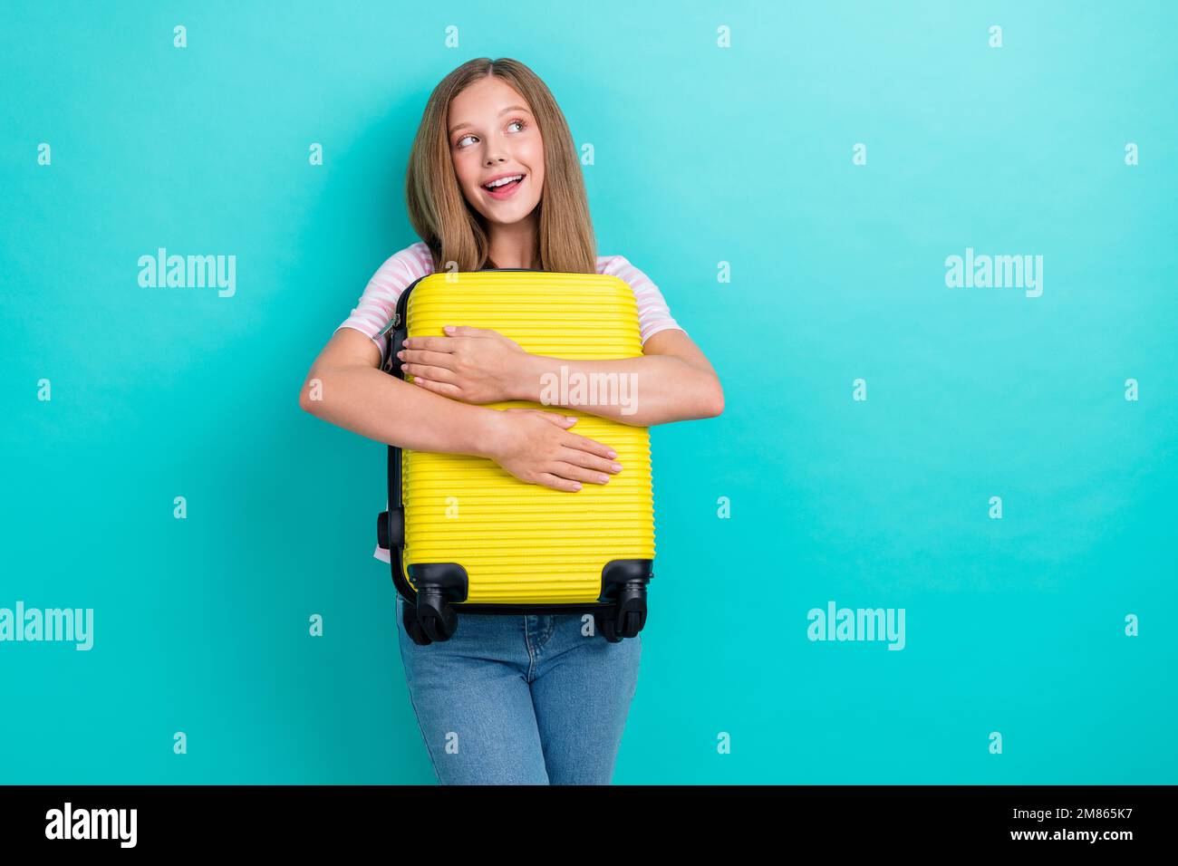 Portrait of positive minded person hands hold suitcase look empty space ...