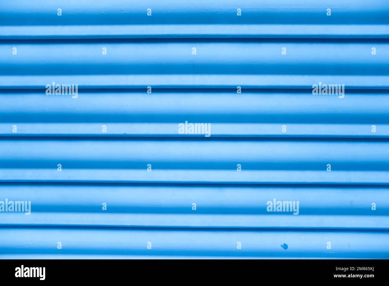 Close-up of a closed blue blind that forms a texture of horizontal ...