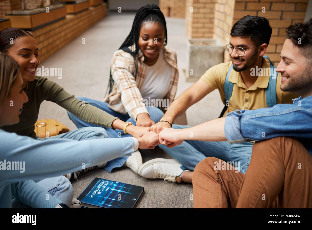 Teamwork, fist bump and hands of students in university for ...