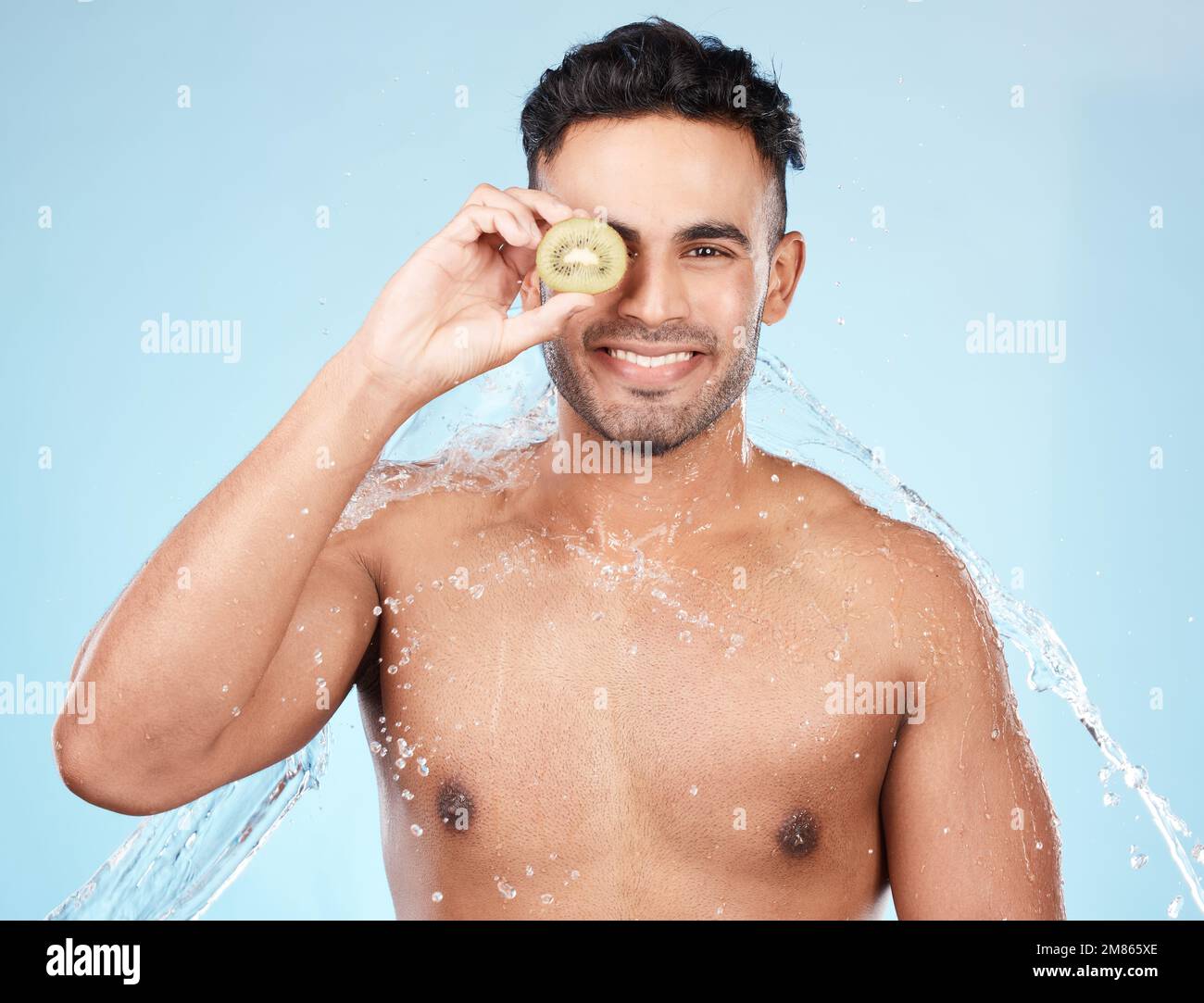 Skincare, beauty and water splash, man with kiwi for vitamin c facial ...