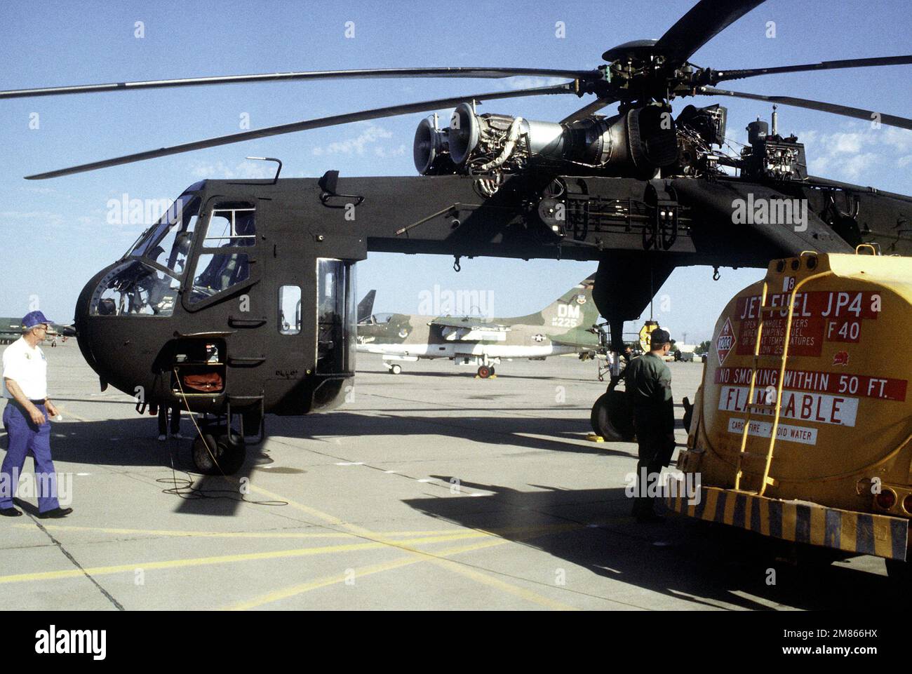 A CH-54 Tahre helicopter is refueled on the flight line before ...