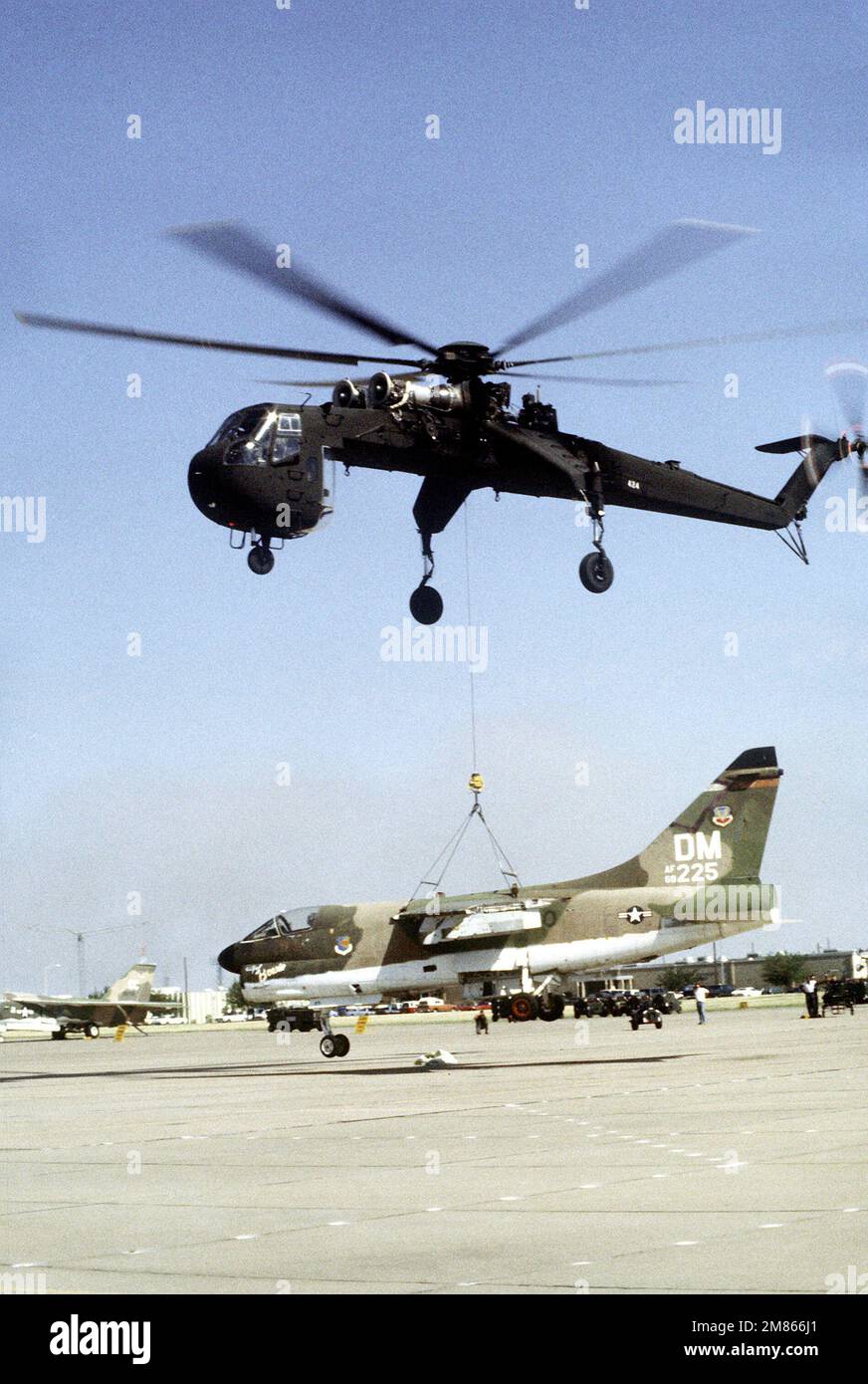 A CH-54 Tahre helicopter airlifts an A-7 Corsair II aircraft. Base: Sheppard Air Force Base ...