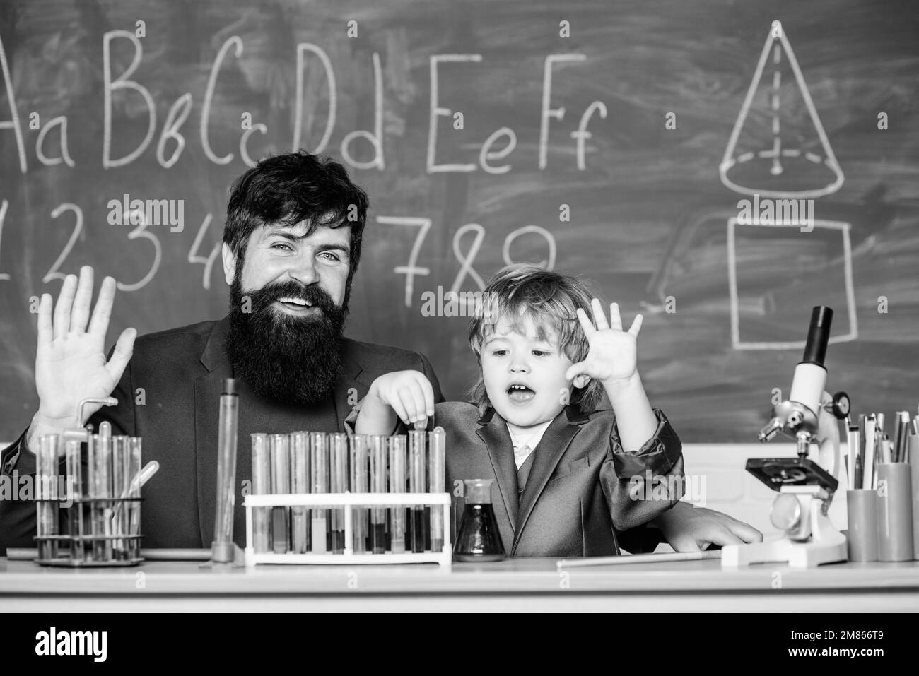 Chemistry and physics biology. father and son at school. biotechnoloy ...