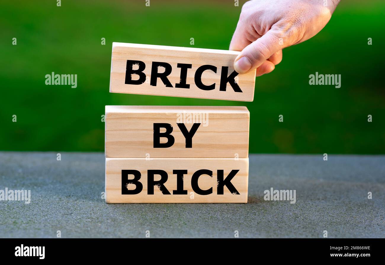 Cubes form the expression 'brick by brick' Stock Photo - Alamy
