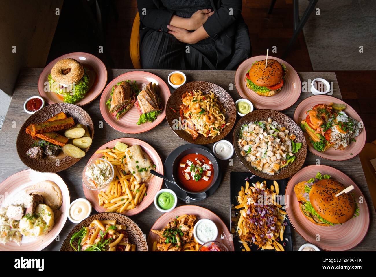 Top view photo of woman sitting at table full of delicious food in ...