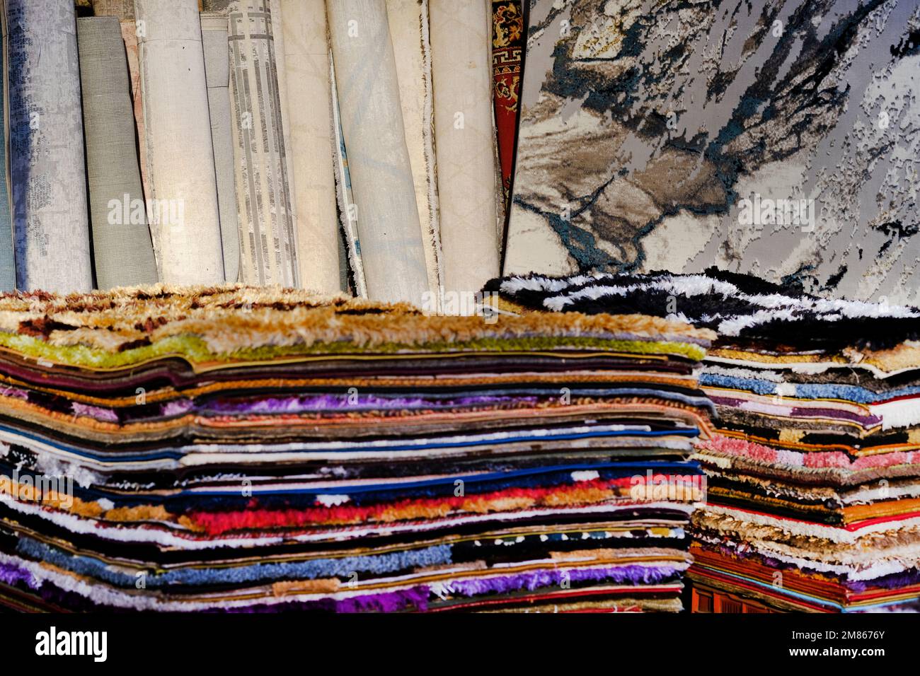 Stack of multicolored quality rugs at carpet shop, Carpets variety ...