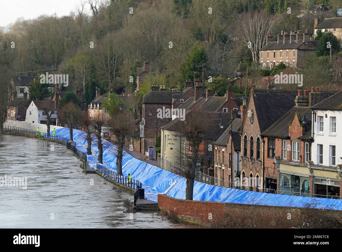 The swollen River Severn, as flood defenses are in place along the ...