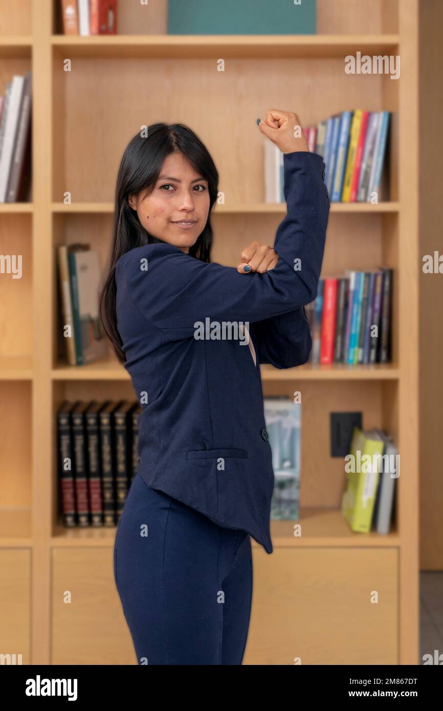 Portrait of young latin woman showing female empowerment sign with her ...