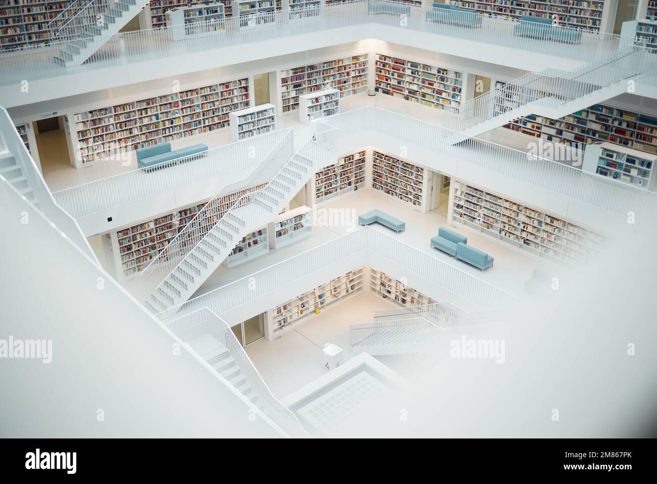 Library, research and education with books in an empty room with stairs ...