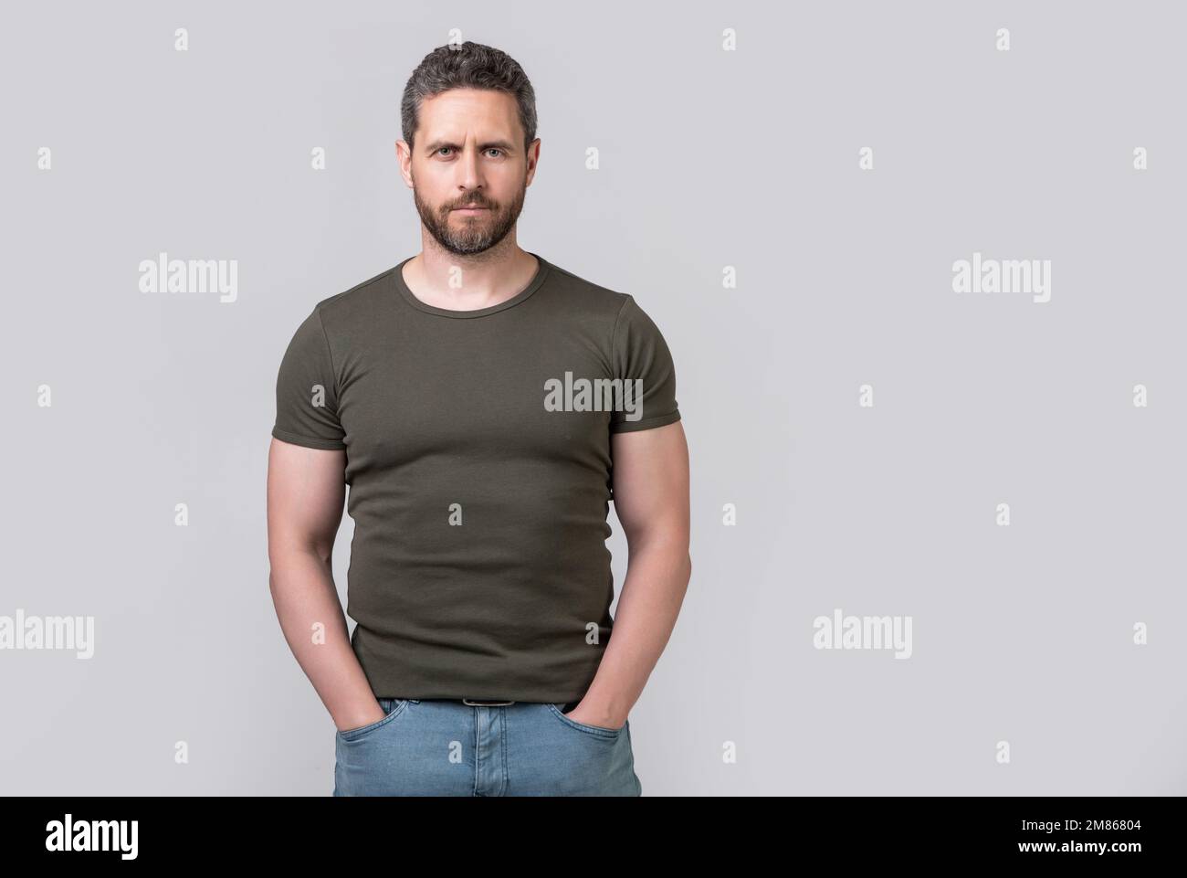 caucasian guy with stubble isolated on grey background, copy space ...