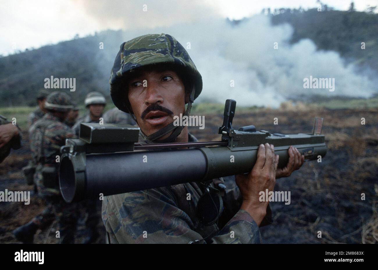 An Ecuadoran commando checks the backblast area before firing an M-72 ...