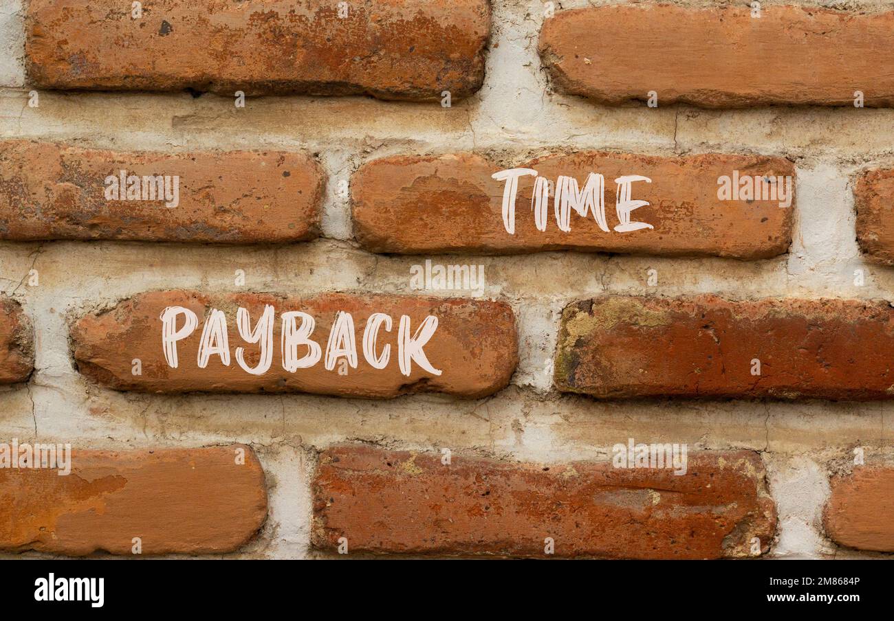 Payback time symbol. Concept words Payback time on brown brick wall ...